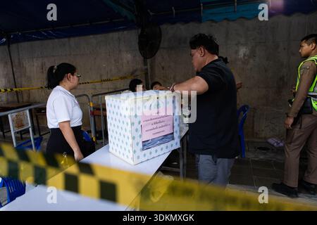 Election officials collect ballot papers during the early voting at ...