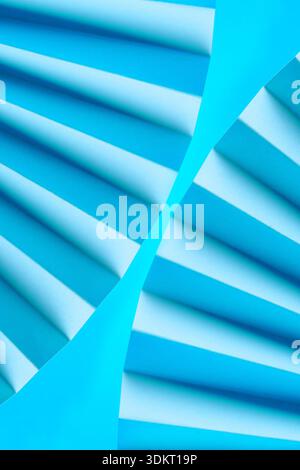 Folded blue paper creating a wave-like pattern Stock Photo - Alamy