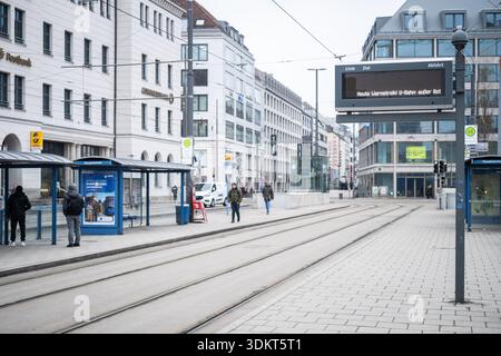 02 February 2026, Munich: Passengers wait for a bus during a nationwide ...