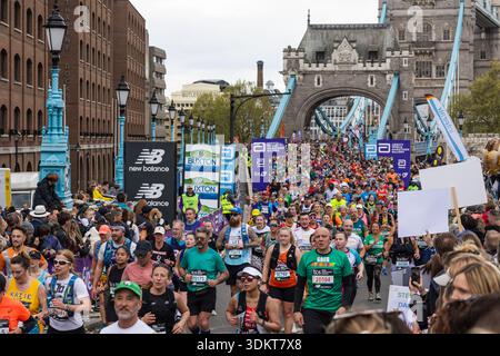 Athletes running across Tower Bridge during London Marathon. London, UK ...
