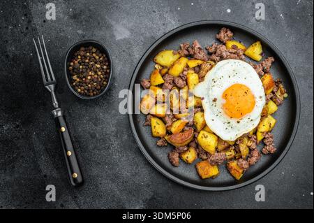 Savory skillet style hash of diced potatoes, ground beef and sunny egg ...