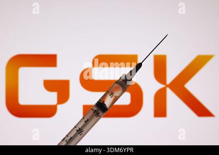In this photo illustration, the GSK logo is displayed on the screen of ...