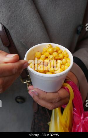 Holding a cup of corn at a street food stand Stock Photo - Alamy