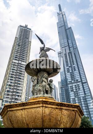 Low-angle view of a winged angel statue blowing a trumpet on a historic ...