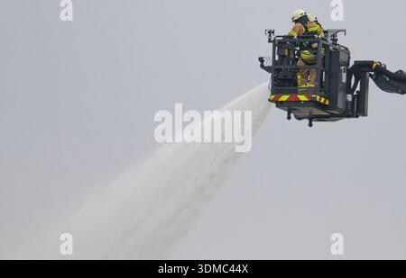 05 February 2026, Hesse, Darmstadt-Wixhausen: Firefighters fight a fire ...