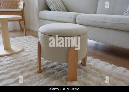 Interior of light living room with soft couch, armchair and coffee ...
