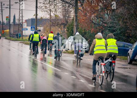 Citizens ride bicycles in the rain on a street in Fuyang, east China's ...