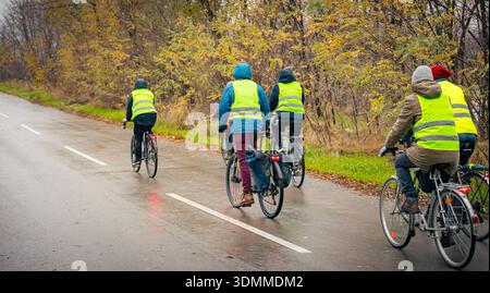 Citizens ride bicycles in the rain on a street in Fuyang, east China's ...