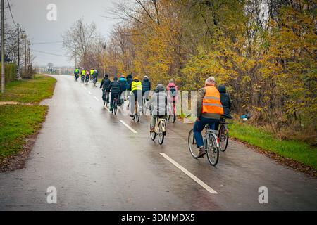 Citizens ride bicycles in the rain on a street in Fuyang, east China's ...