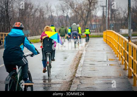 Citizens ride bicycles in the rain on a street in Fuyang, east China's ...
