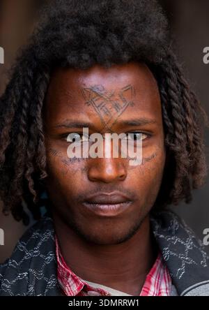 Portrait of a young Afar man with curly hair in Mille, Afar Region ...