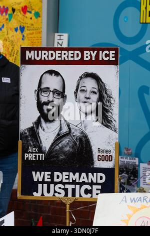 A sign displaying portraits of Alex Pretti and Renee Good surrounded by ...