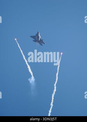 An F-22 Raptor releases flares during an aerial demonstration at Naval ...