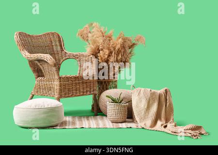 Wicker armchair with pampas grass and rug on beige background Stock ...