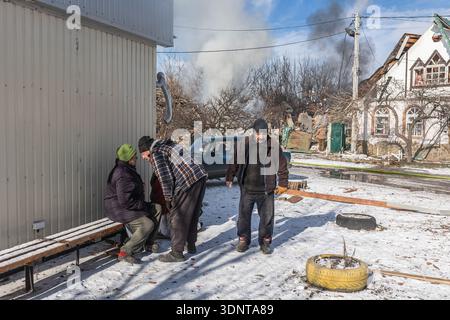 Residents seen sitting next to their damaged homes after a Russian ...