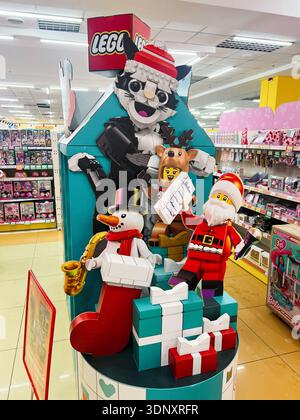 Festive wrapped gifts including a red Merry Christmas box stacked on ...