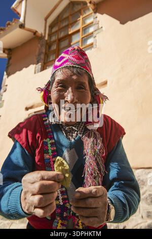 Indigenous guide sacrifices a package of Coca leaves in front of the ...