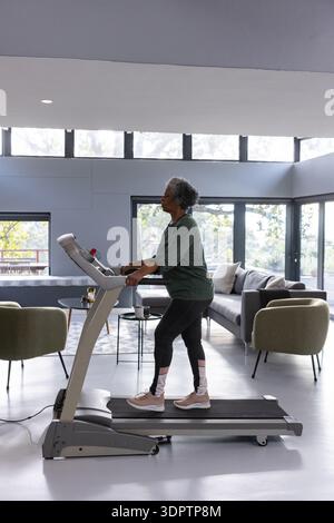 Modern walking treadmill in living room. Home gym equipment Stock Photo ...