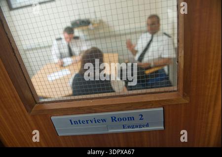 Police officers interviewing a suspect - played by a model Stock Photo ...