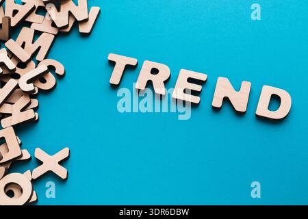 On Trend, words in wooden alphabet letters isolated on blue background ...