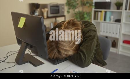 Blond man with long hair typing on a desktop keyboard while staring at ...