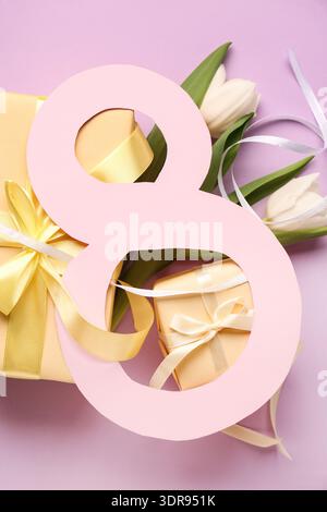 Figure 8 with lilac flowers, gift boxes and wrapping paper on beige ...
