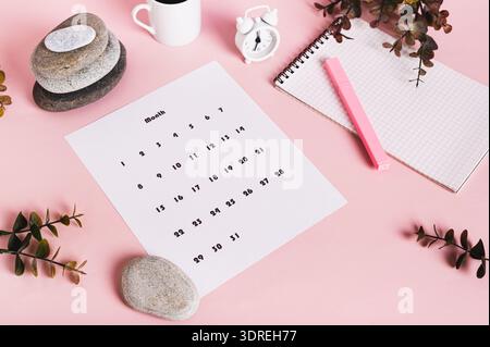 Calendar with alarm clock, notebook, paper pins and pen on beige ...