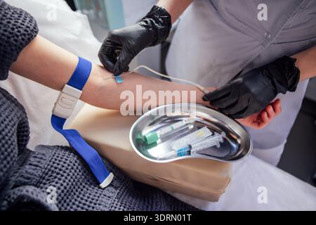 A health worker prepares a patient's blood sample for testing at Bunia ...