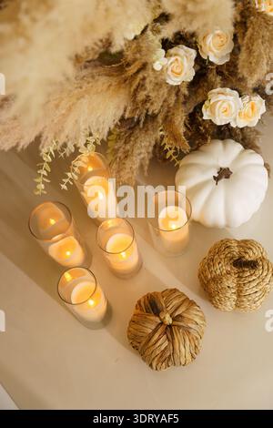 Cozy evening scene with candles, white wine glasses and warm candle ...