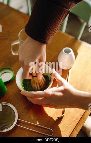 Hands whisking matcha. A traditional Japanese green tea. The calming ...