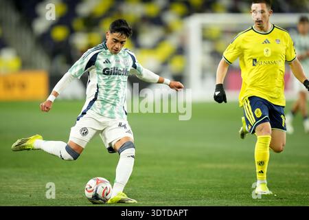 New England Revolution defender Tanner Beason (4) hits the ball off his ...