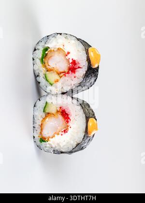 Two golden tempura sushi rolls with salmon, avocado, and cream cheese ...