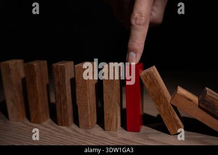 insurance with hands protect domino. Businessman hands stop dominoes ...