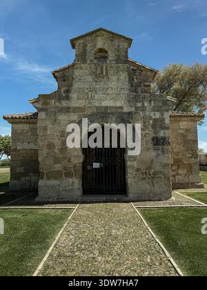 Stone exterior of a historic Visigothic basilica with arched entrance ...
