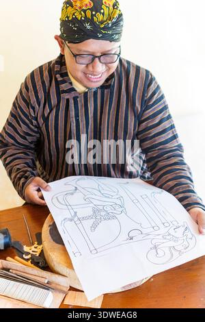 Artisan hands drawing design on wood plank using pencil and template ...