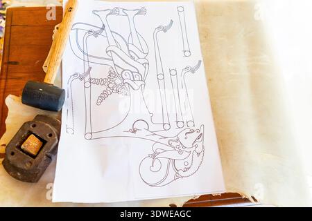 Wood artisan tracing design pattern on timber, crafting custom wooden ...