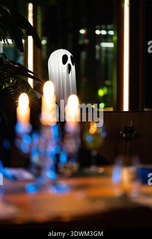 Cozy evening scene with candles, white wine glasses and warm candle ...