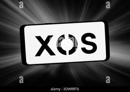 In this photo illustration, a Xos Inc logo is seen displayed on a ...