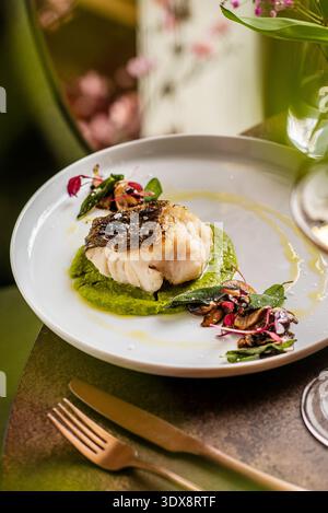 Crispy Skin Fish Served on a Bed of Vibrant Greens With a Side of ...