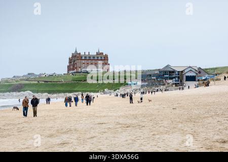The iconic Headland Hotel overlooking people walking along Fistral ...