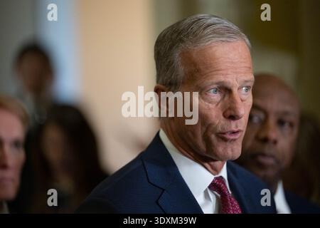 Senate Majority Leader John Thune, R-S.D., left, listens as President ...
