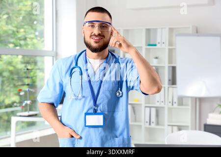 Male doctor in AR glasses using virtual screen on light background ...