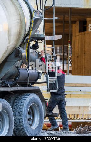 Mixer truck pouring concrete on a roadworks construction site in ...