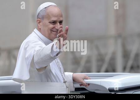 Pope Leo XIV waves as he arrives on the popemobile at Piazza Calipari ...