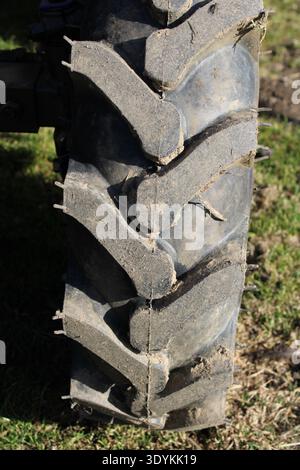 Farm field shows muddy ground with tire tracks and trees in Westhead ...