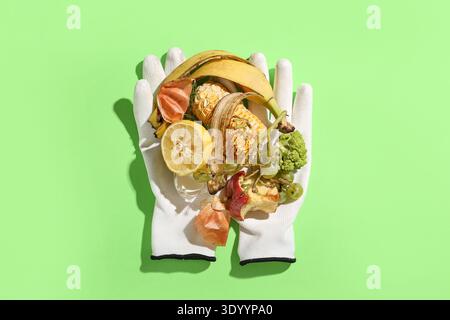 Different organic waste with gloves on green background. Compost ...