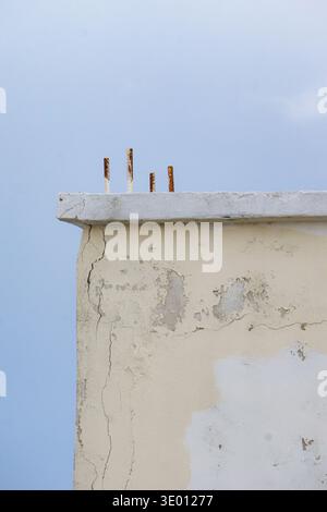 Weathered cracked plaster wall with exposed old stone masonry texture ...
