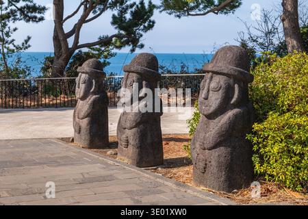 Dol hareubang (grandfather stone) volcanic rock statues along the Jeju ...