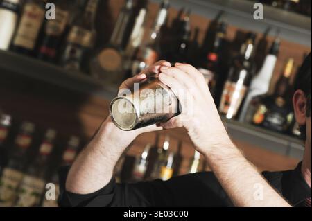 a barkeeper or bartender mixing drinks together in a bar barkeeper ...