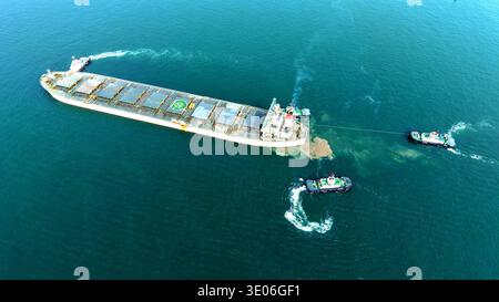 A cargo ship loaded with imported iron ore sails to Qingdao Port via ...